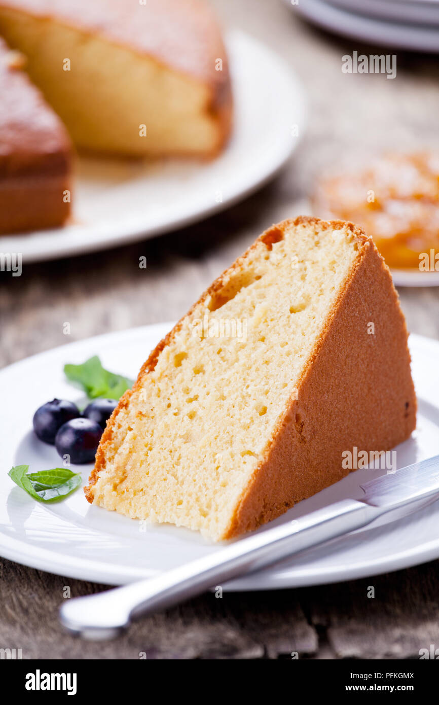 Slice of a homemade vanilla cake for breakfast Stock Photo - Alamy