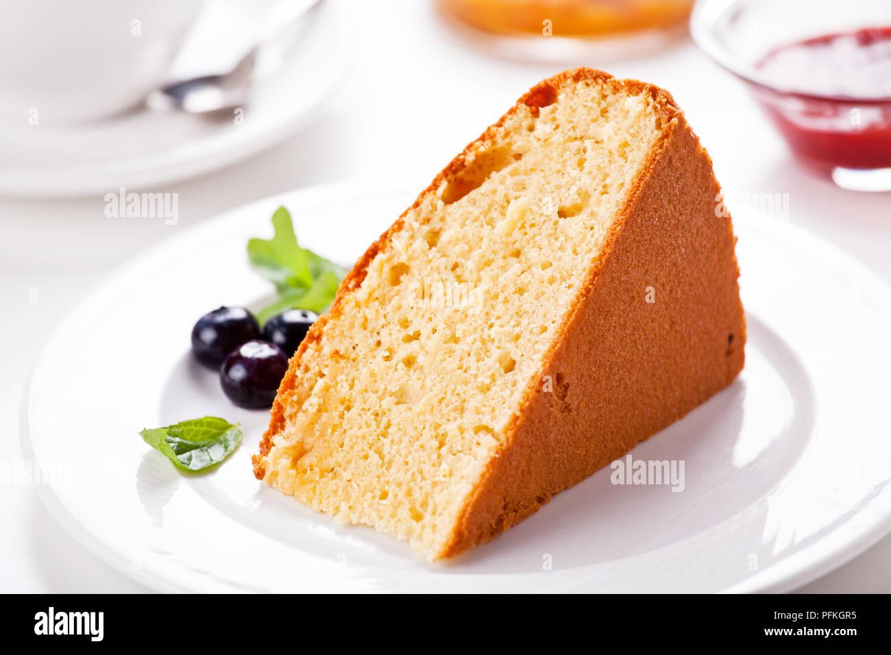Slice of a homemade vanilla cake for breakfast Stock Photo - Alamy