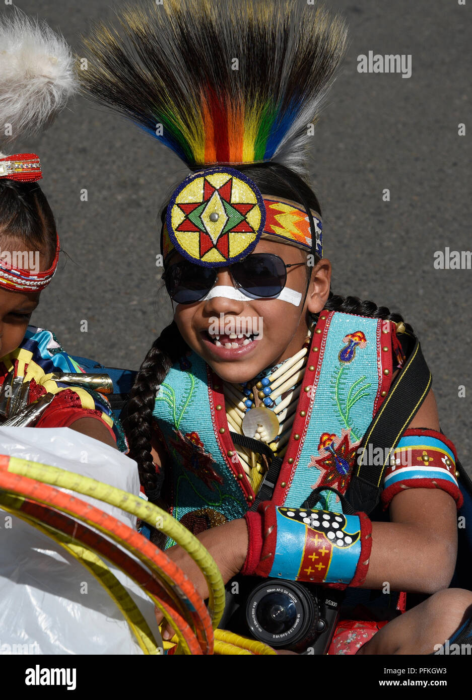A young Native-American boy wearing traditional Plains Indian regalia ...