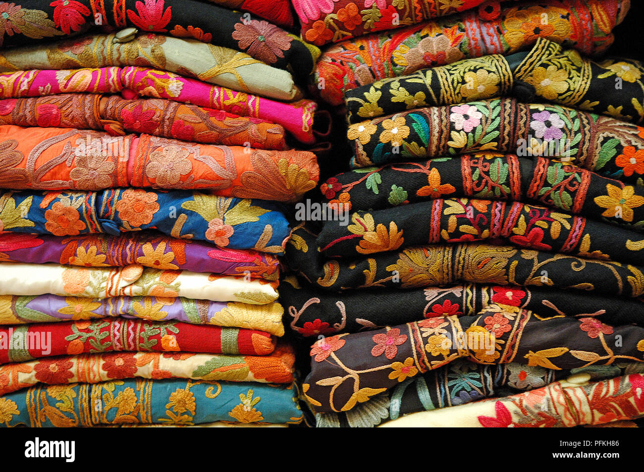 United Arab Emirates, Dubai, stack of colourful textiles on display in ...
