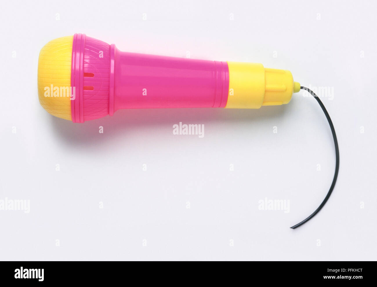 Pink and yellow toy microphone, close-up Stock Photo - Alamy