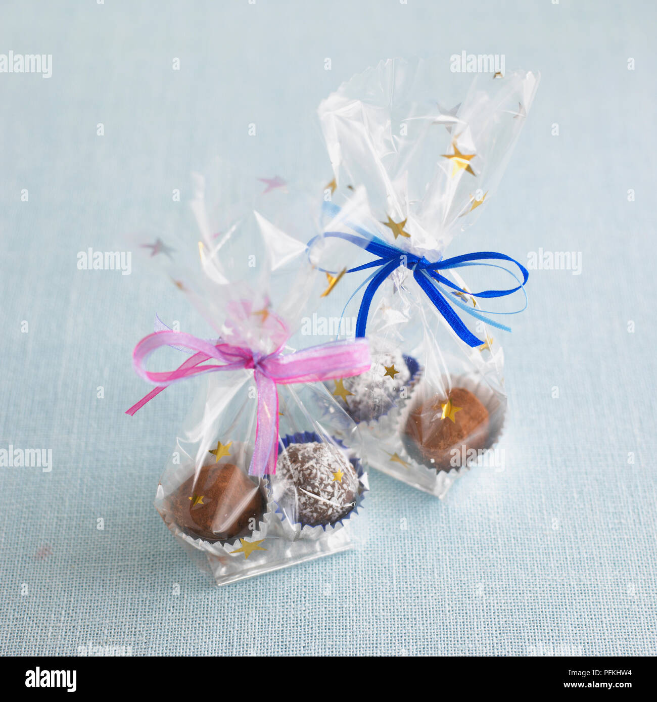Chocolate truffles wrapped in plastic, tied together with ribbons Stock ...