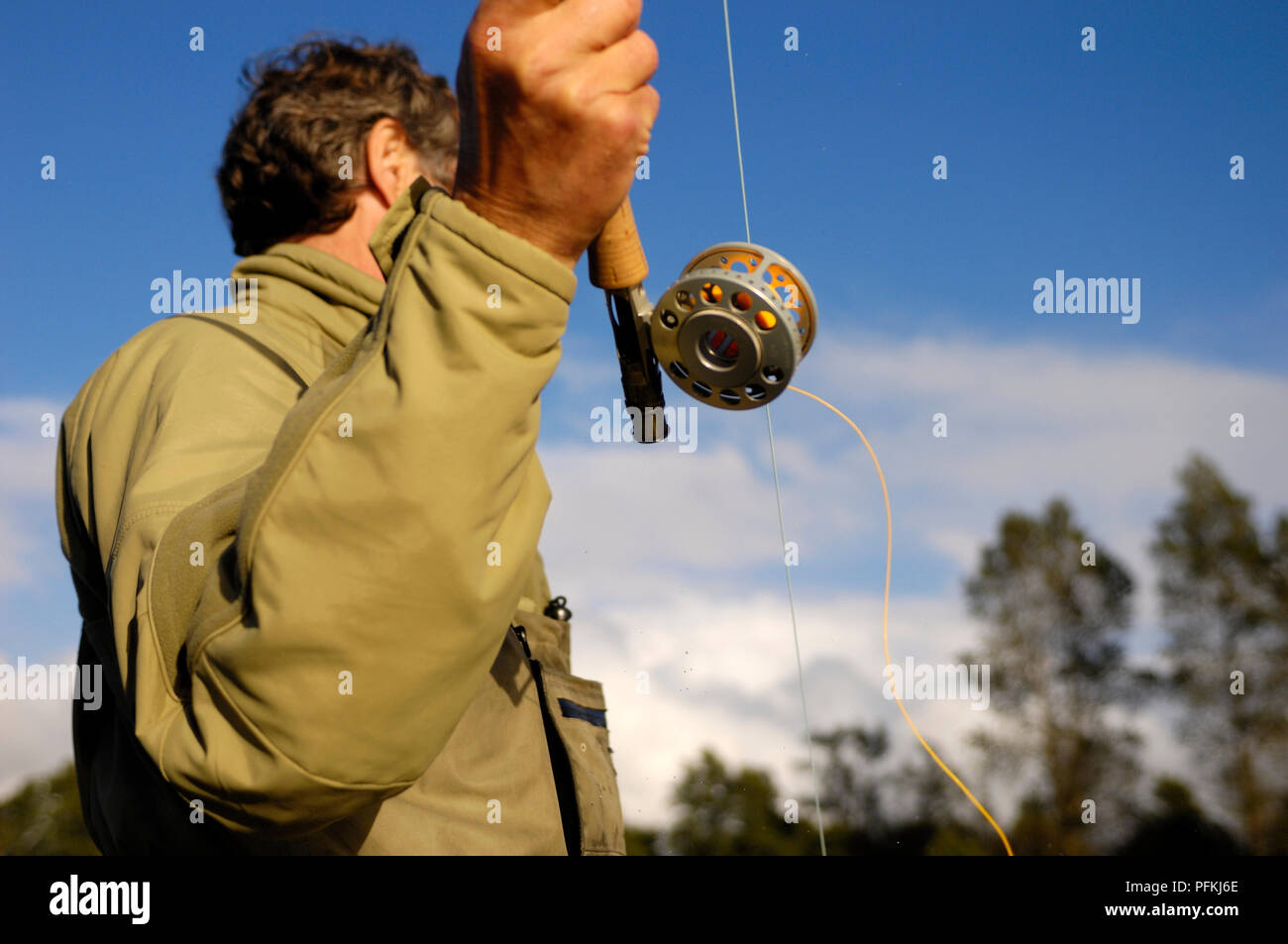 Man's hand holding fishing rod, close-up Stock Photo - Alamy