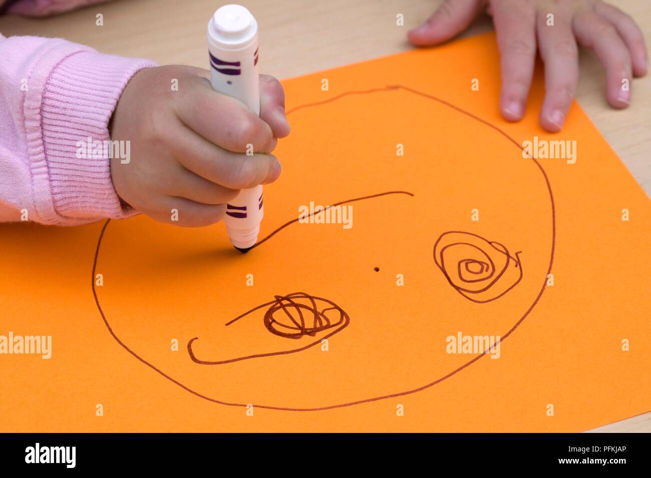 Girl's hand drawing face with marker pen, close-up Stock Photo - Alamy