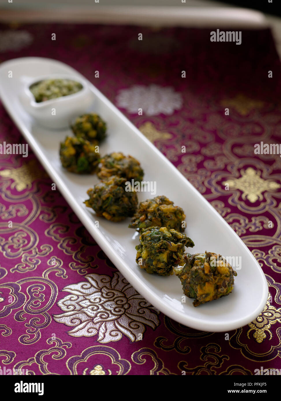 Palak pakoras, spinach, onion and potato fritters, served with chutney ...