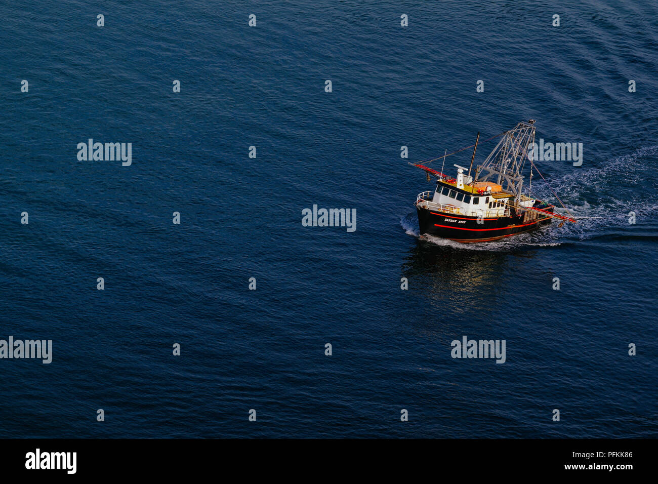 Commercial fishing trawler heading out to sea in from the tweed River ...