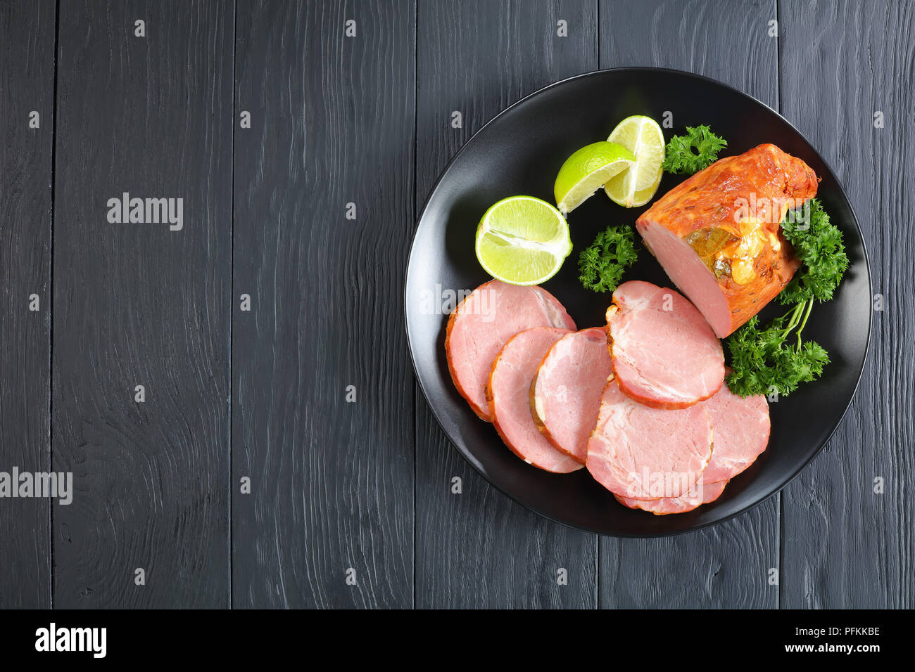 delicious ham cut in slices served with parsley and fresh citrus wedges ...