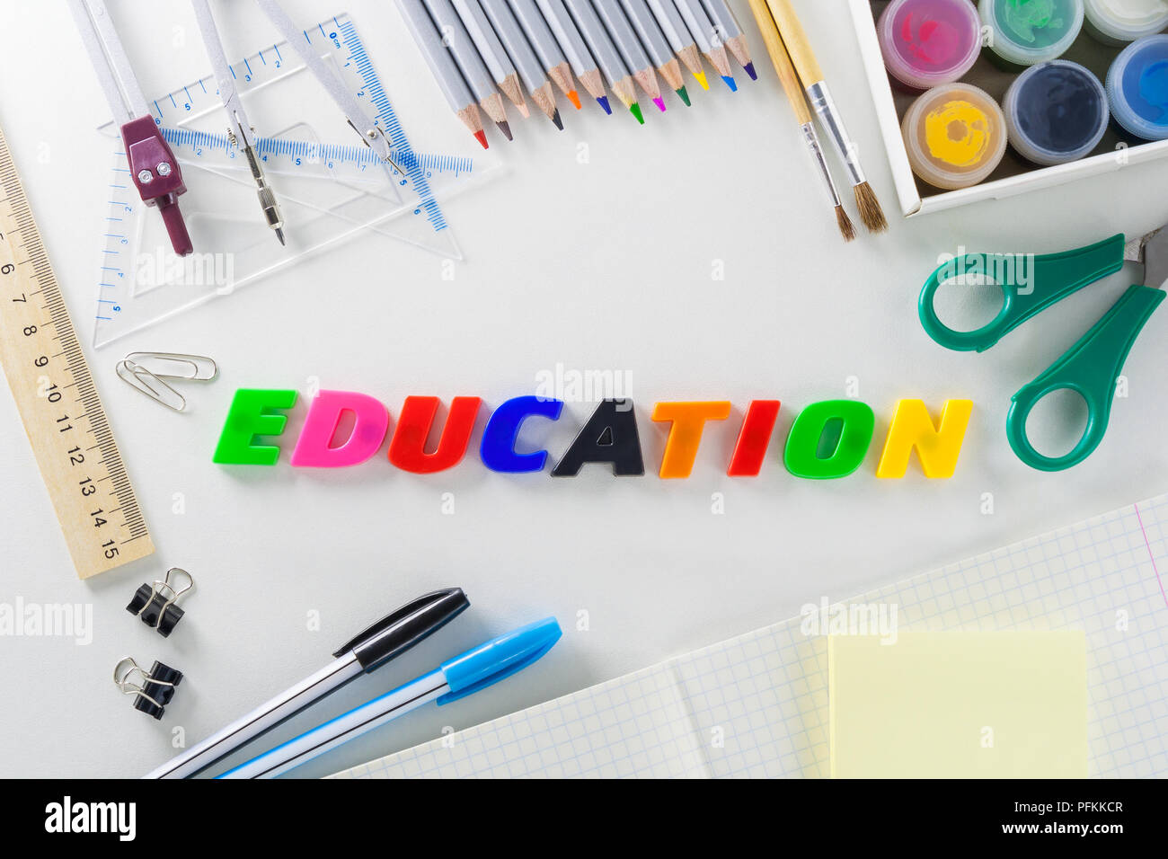The word "Education" from multi-colored plastic letters on a white ...