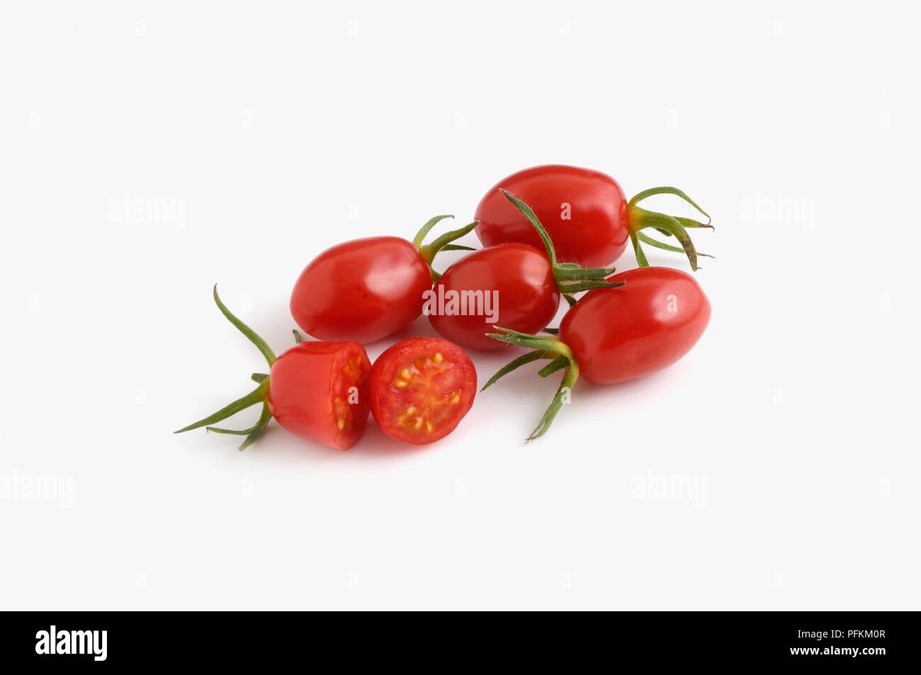 Whole and sliced Taiwanese red Rosada plum-cherry hybrid tomatoes Stock ...