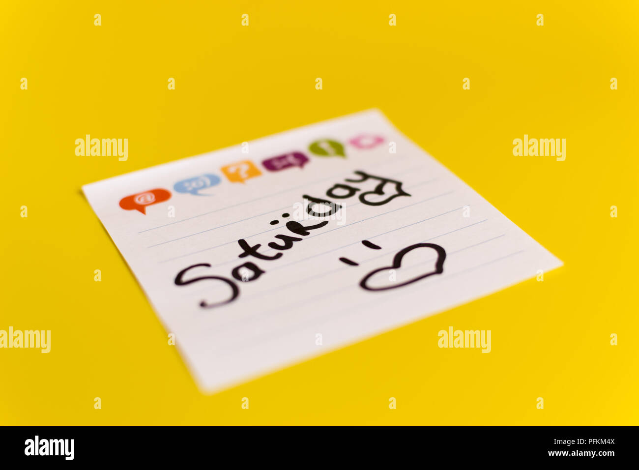 inscription in black marker Saturday on white sticker yellow background ...