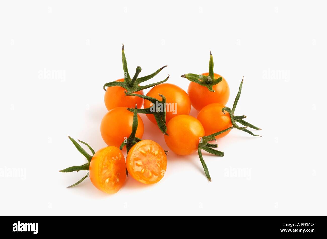 Whole and sliced Sunset tomatoes Stock Photo - Alamy