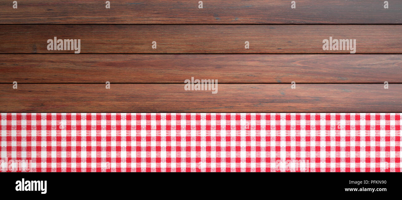 Red and white checkered picnic tablecloth on wooden table, banner, copy ...