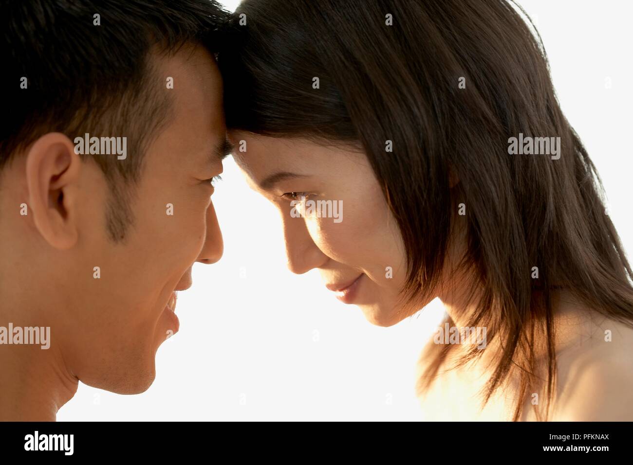 Headshot of man and woman standing face to face, side view Stock Photo ...