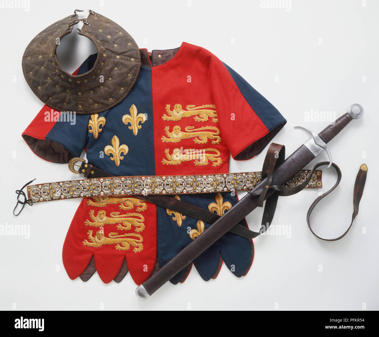 A sword and sheath, a blue and red tunic with royal insignia on it, a ...