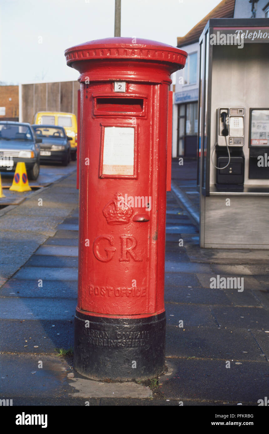 Great Britain, red, free-standing post box with telephone box and cars ...