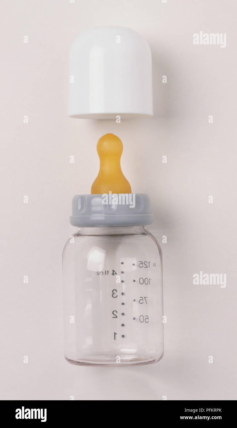 Baby feeding bottle with measuring marks and cap Stock Photo - Alamy