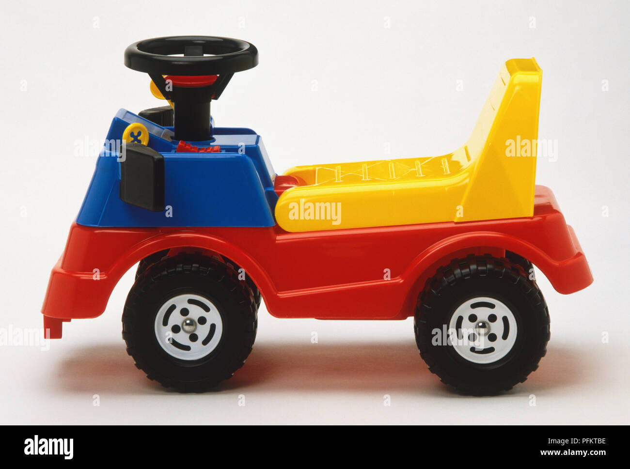 Child's colourful sit-on truck, side view Stock Photo - Alamy