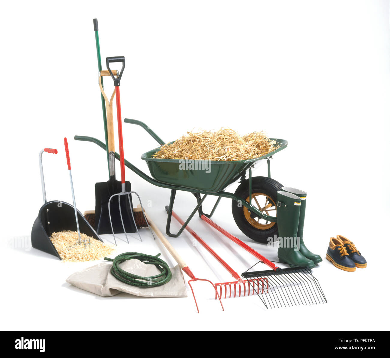 Agricultural and gardening equipment, including wheelbarrow full of ...