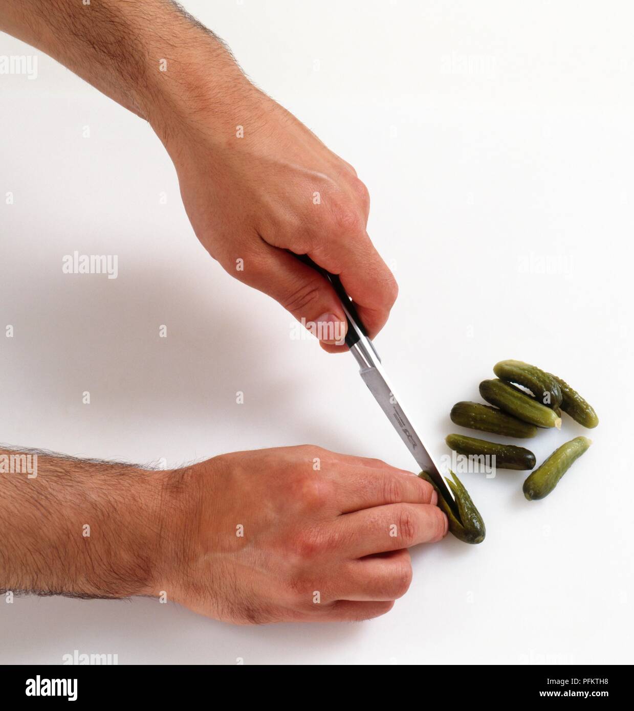 Hand with gherkin hi-res stock photography and images - Alamy