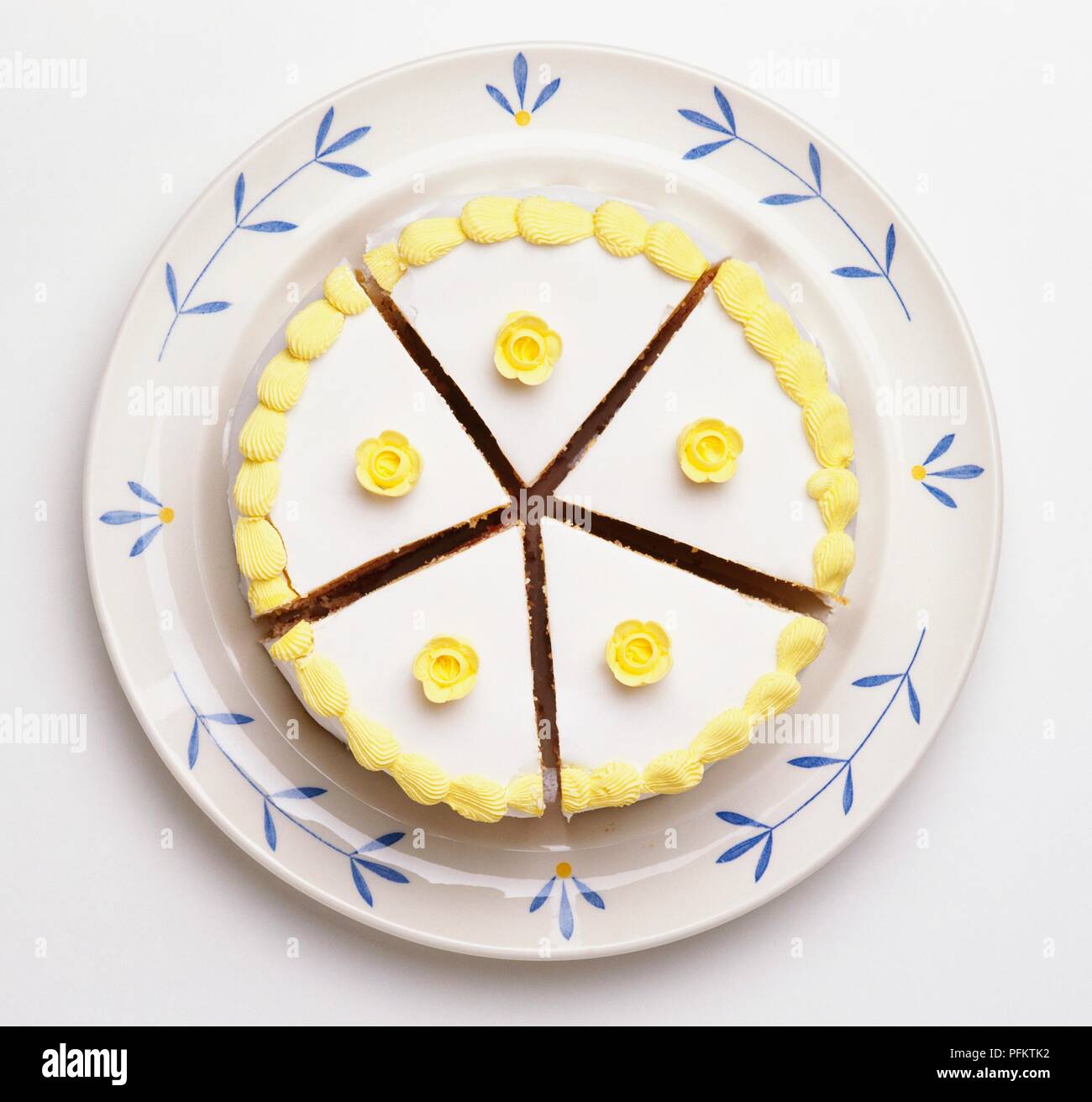 Cake cut into five slices, covered with white icing and yellow iced ... Cake cut into five slices, covered with white icing and yellow iced ...