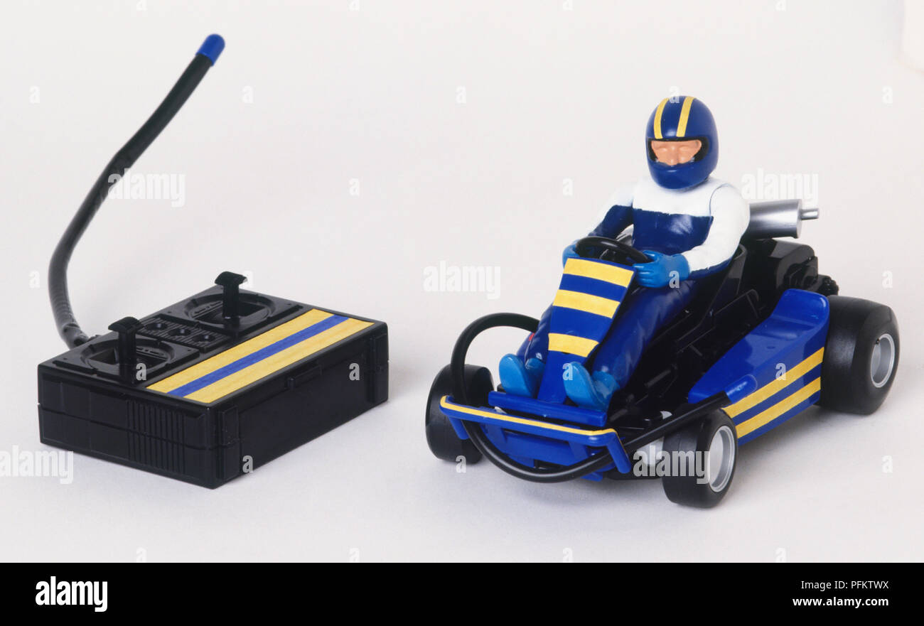 A yellow and blue remote controlled car with driver and remote control ...
