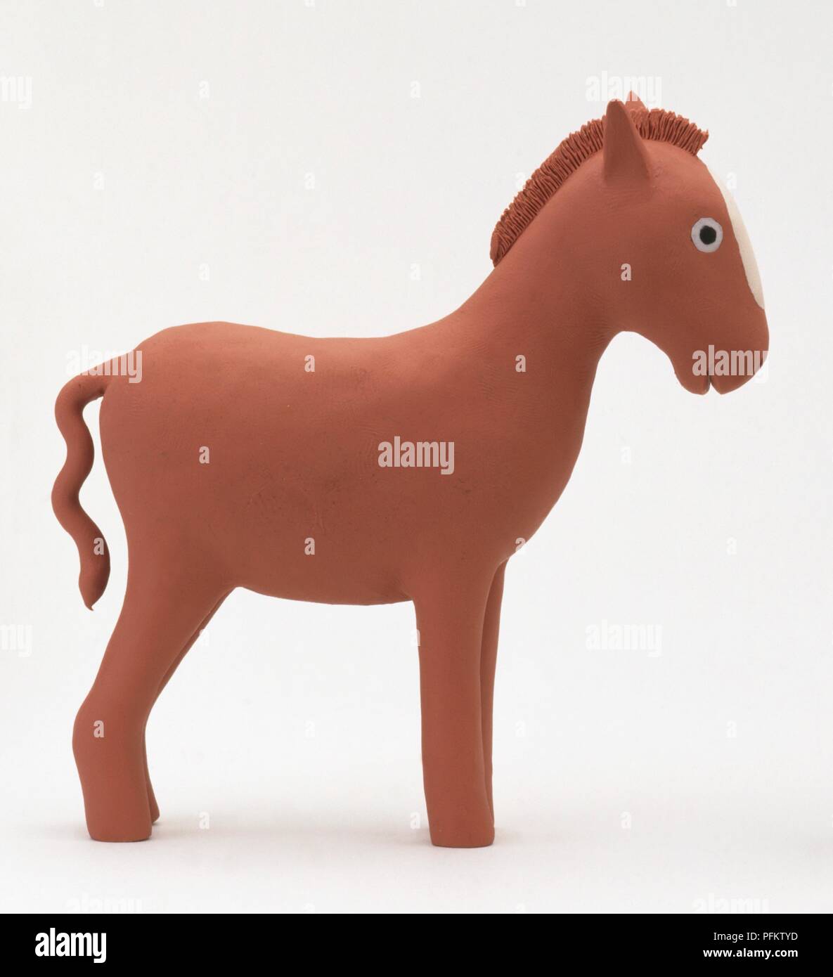 Brown horse made out of modelling clay, side view Stock Photo - Alamy