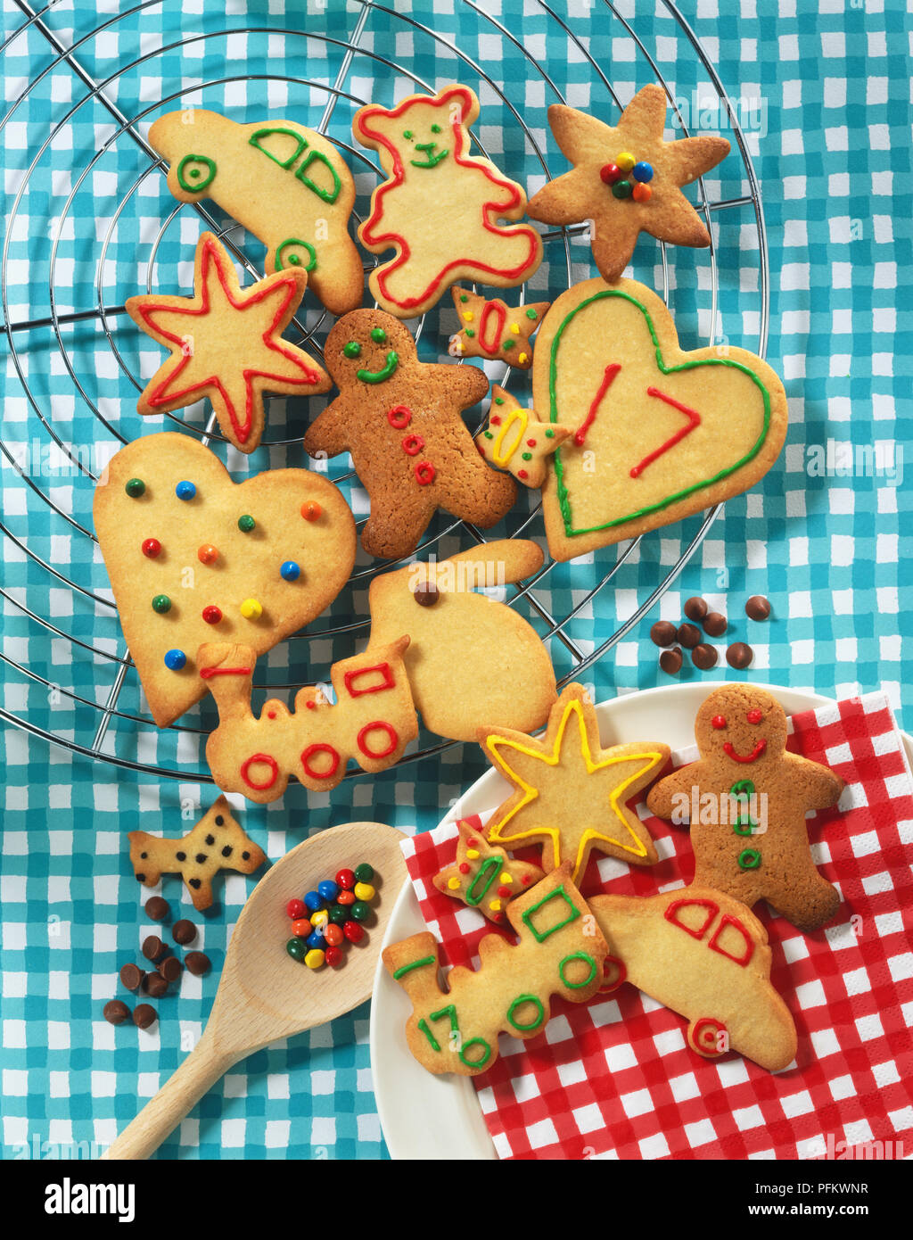 Different shaped biscuits, including hearts and stars, on a wire cooler ...