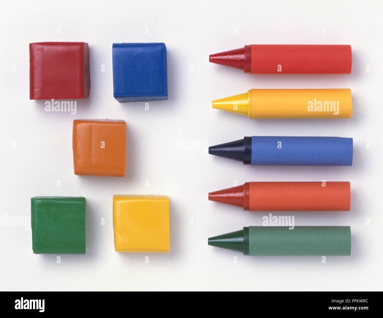 Multi-coloured crayons and cubes of modelling clay Stock Photo - Alamy