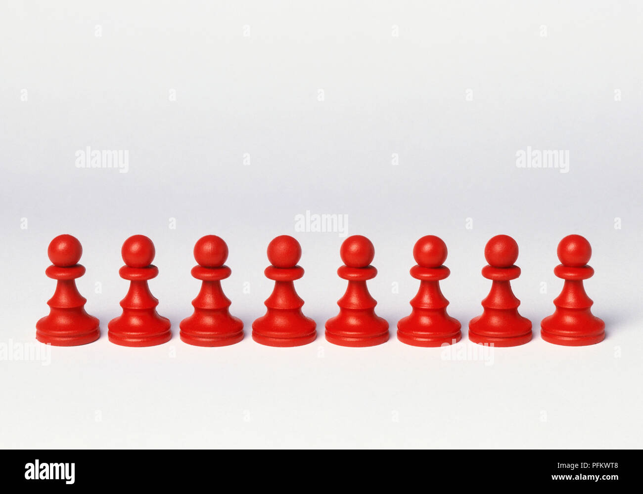 Row of red pawn chess pieces Stock Photo - Alamy