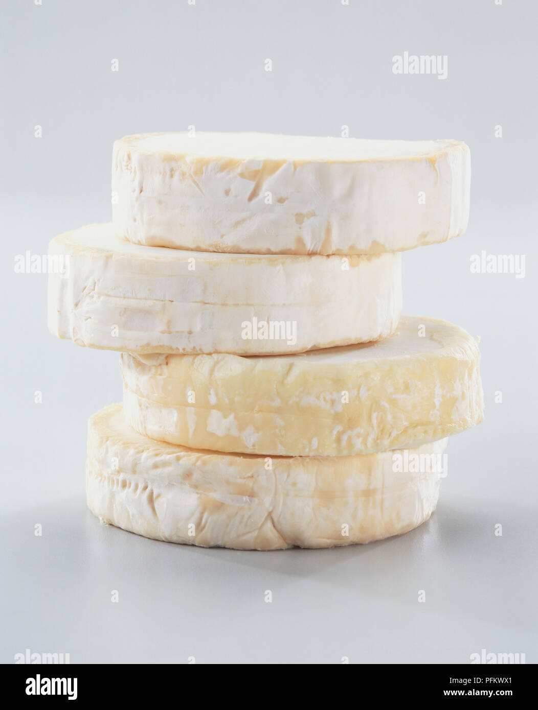 Four round slices of goat's cheese Stock Photo - Alamy