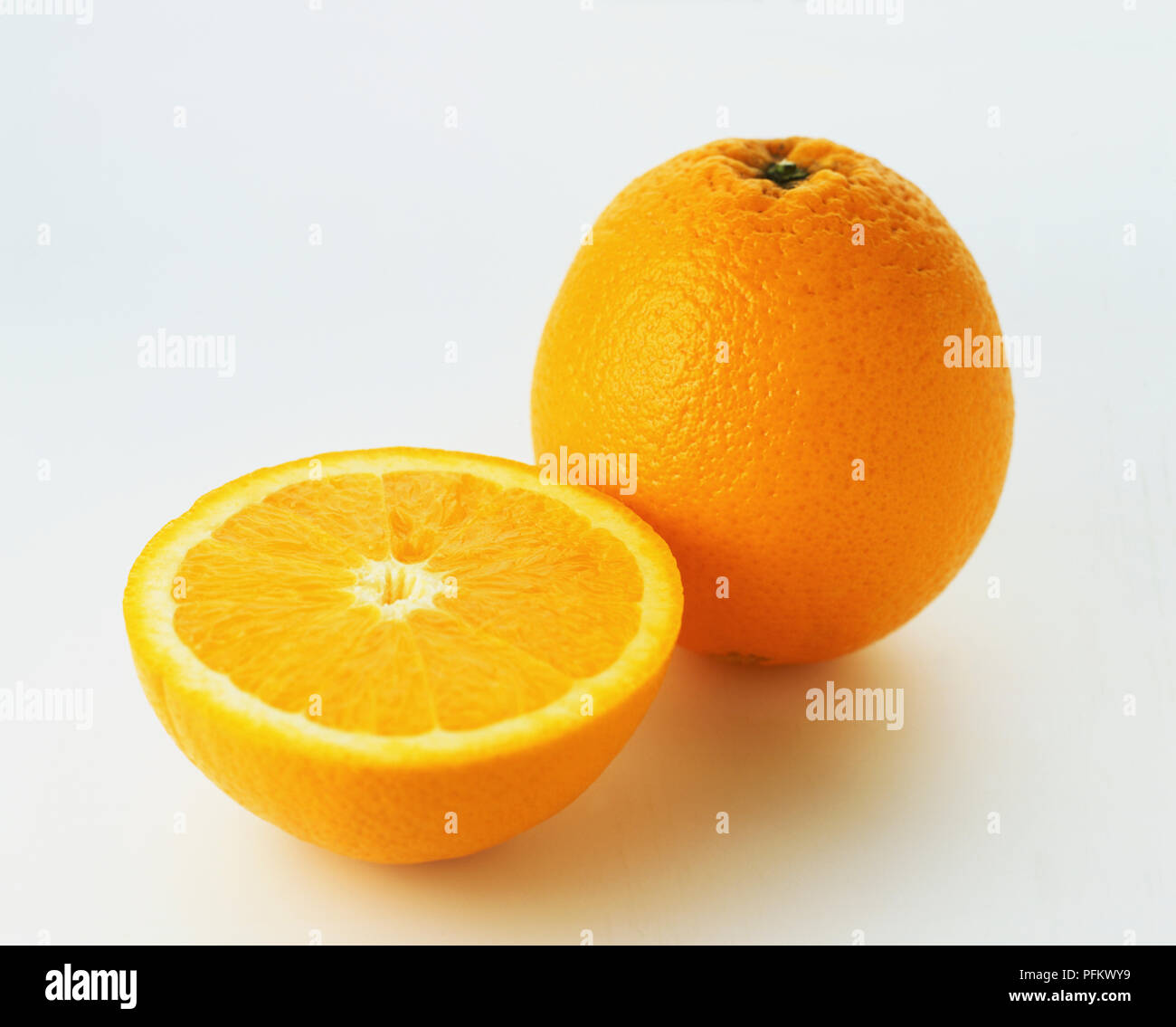 Whole orange and half an orange Stock Photo - Alamy