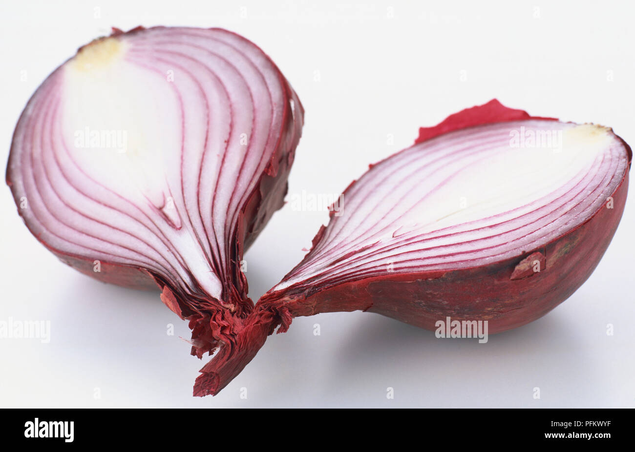 Red onion sliced in half, showing cross section and distinctive papery ...