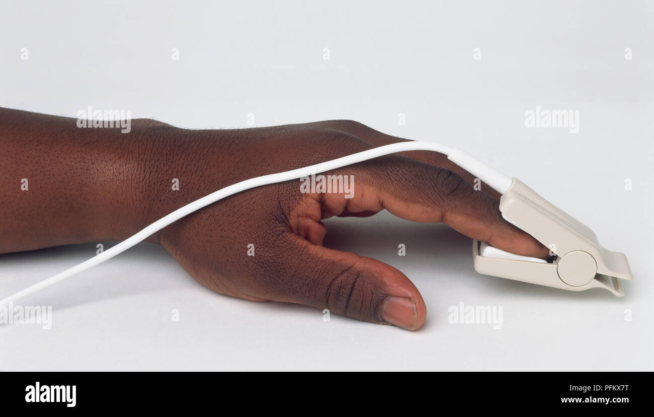 Hand wearing pulse oximeter Stock Photo - Alamy