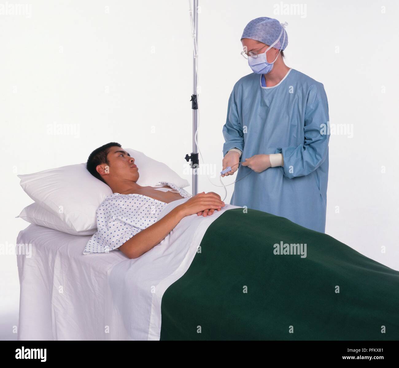 Female doctor in protective clothes using a regulator to give patient a ...