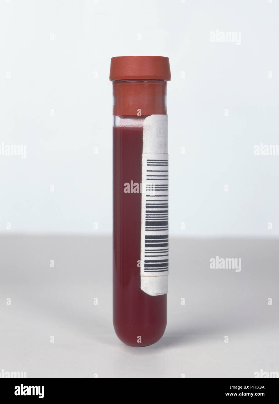 Glass phial, with a bar code on it, containing a sample of blood Stock ...