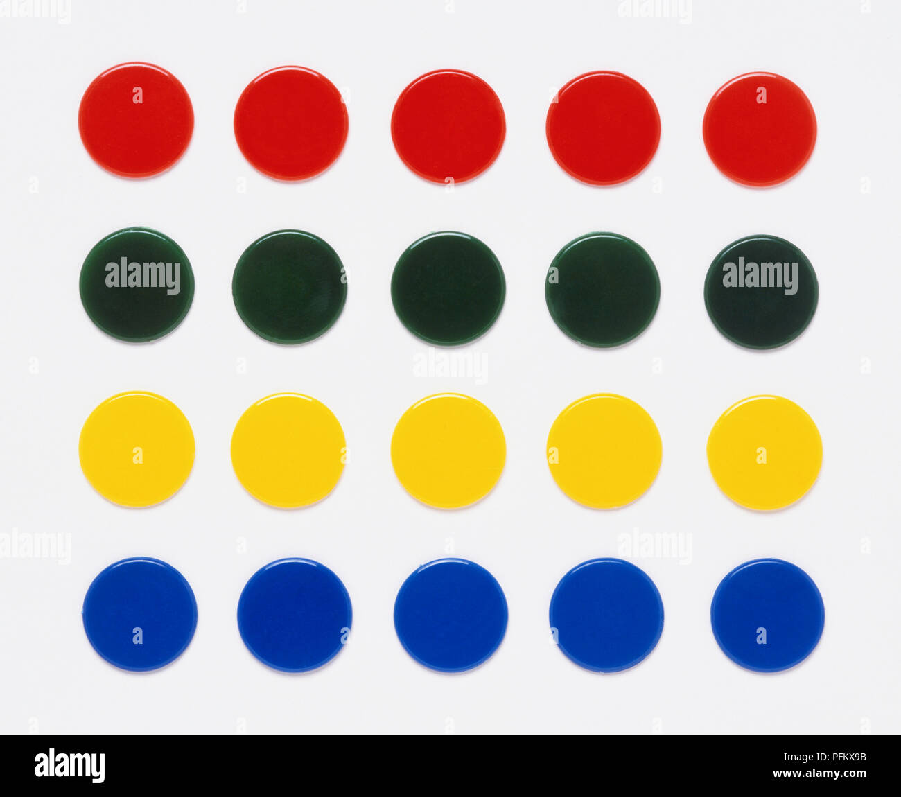 Coloured discs in four rows, blue, yellow, black and red Stock Photo ...