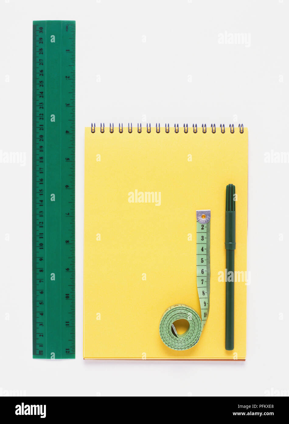 Plastic ruler, notepad, pen and tape measure Stock Photo - Alamy