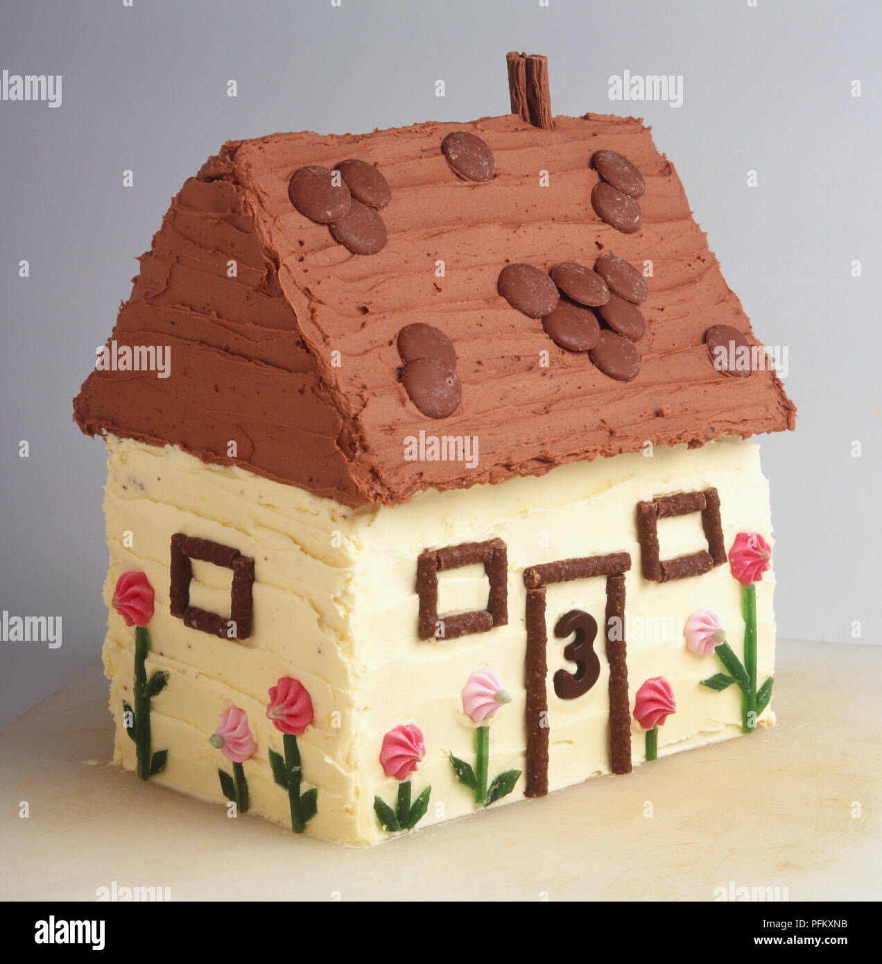 Cake in the shape of a cottage decorated with buttercream icing Stock ...
