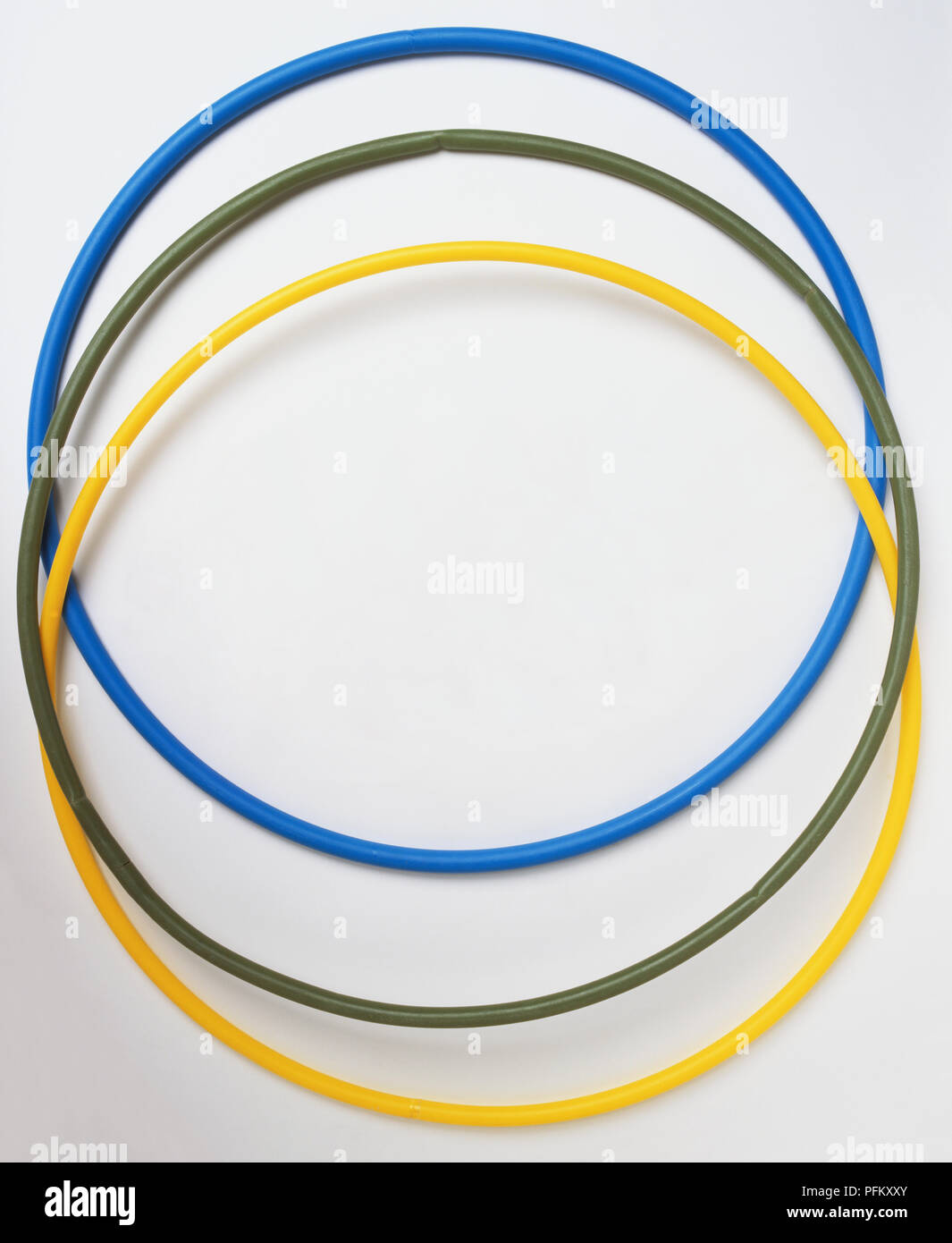 Three plastic hoops, yellow, green and blue Stock Photo - Alamy