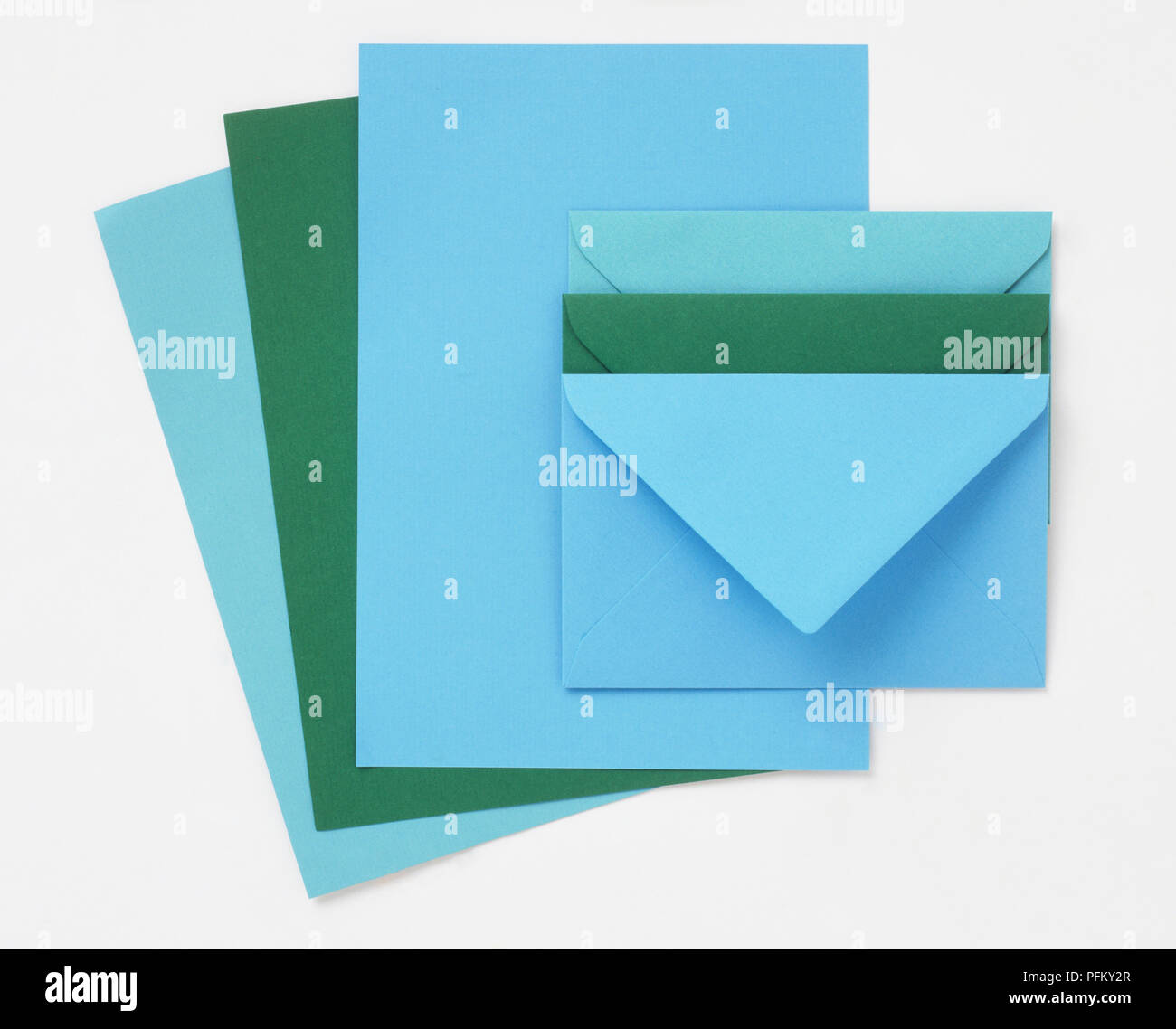 Blue and green envelopes and sheets of paper Stock Photo - Alamy