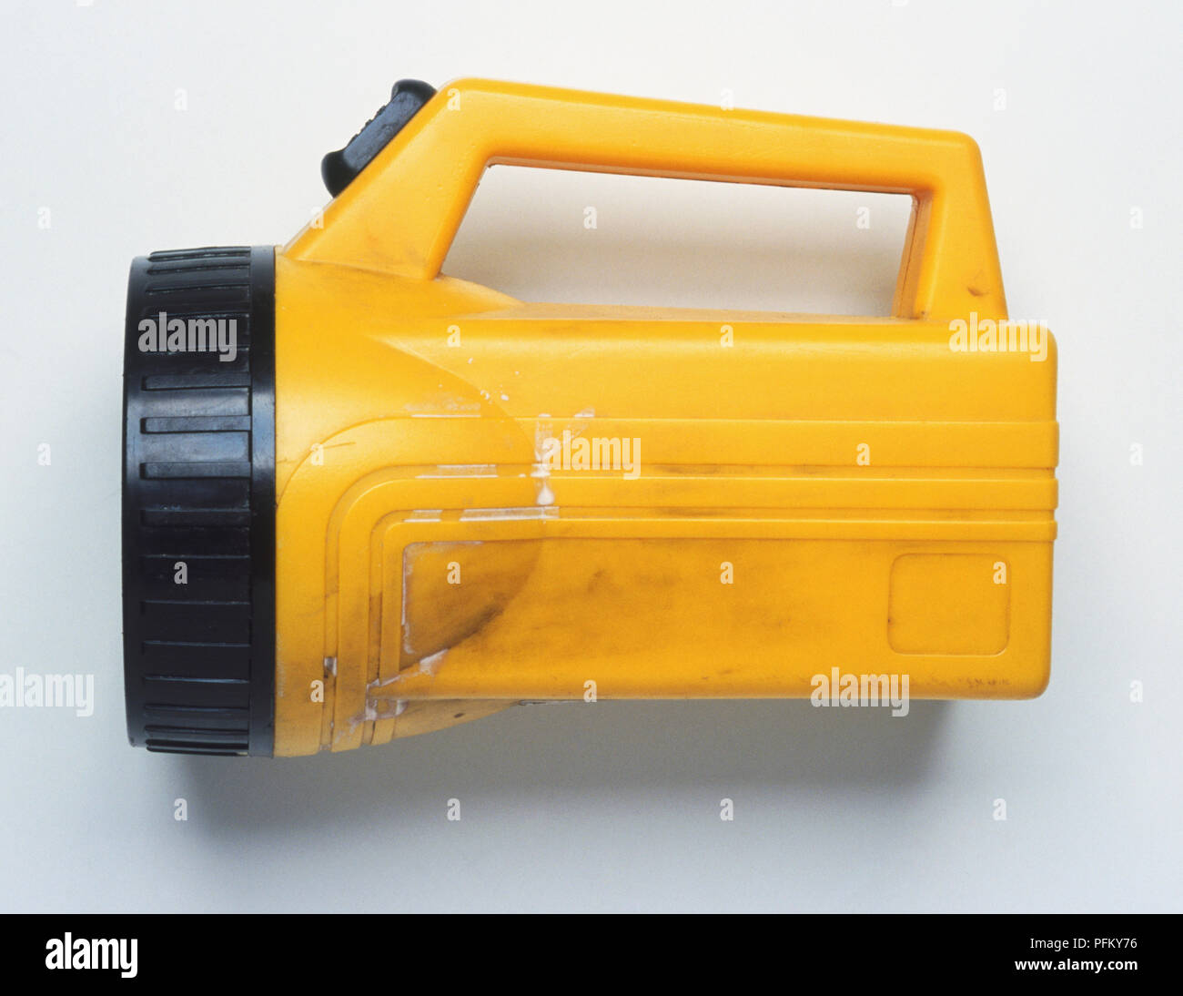 Yellow and black plastic torch with a handle at top, side view Stock ...