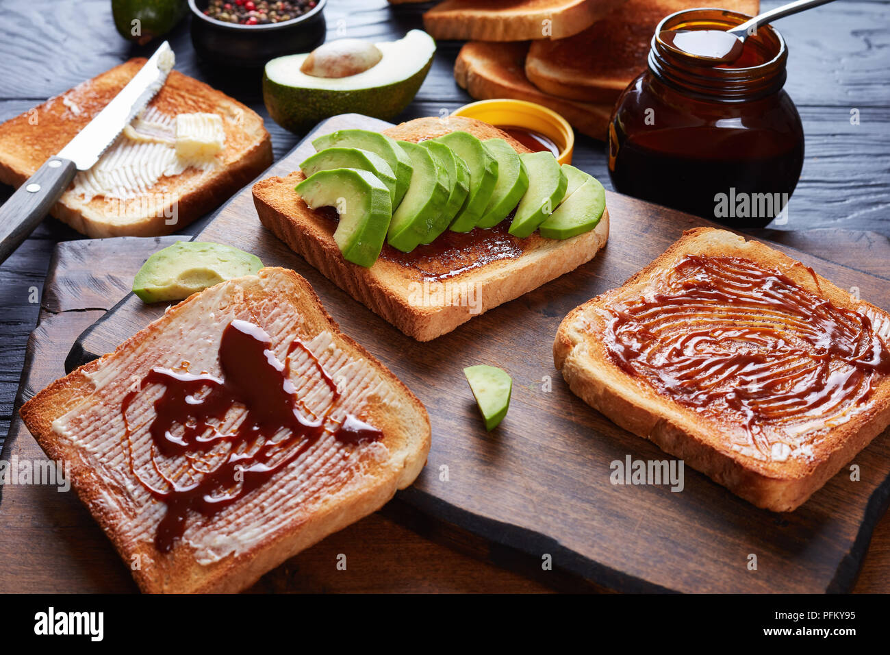 spicy healthy toasts with butter, avocado slices and spread made from ...