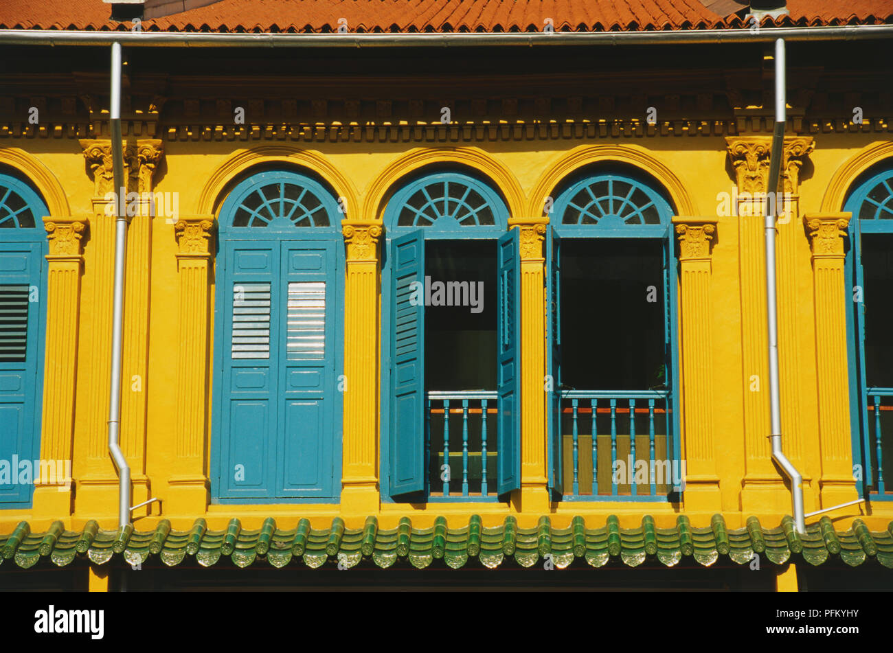 Upper windows with shutters of the brightly painted restored double ...