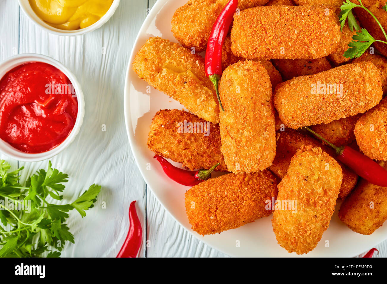 spanish deep-fried golden brown potato croquettes, croquetas on a white ...