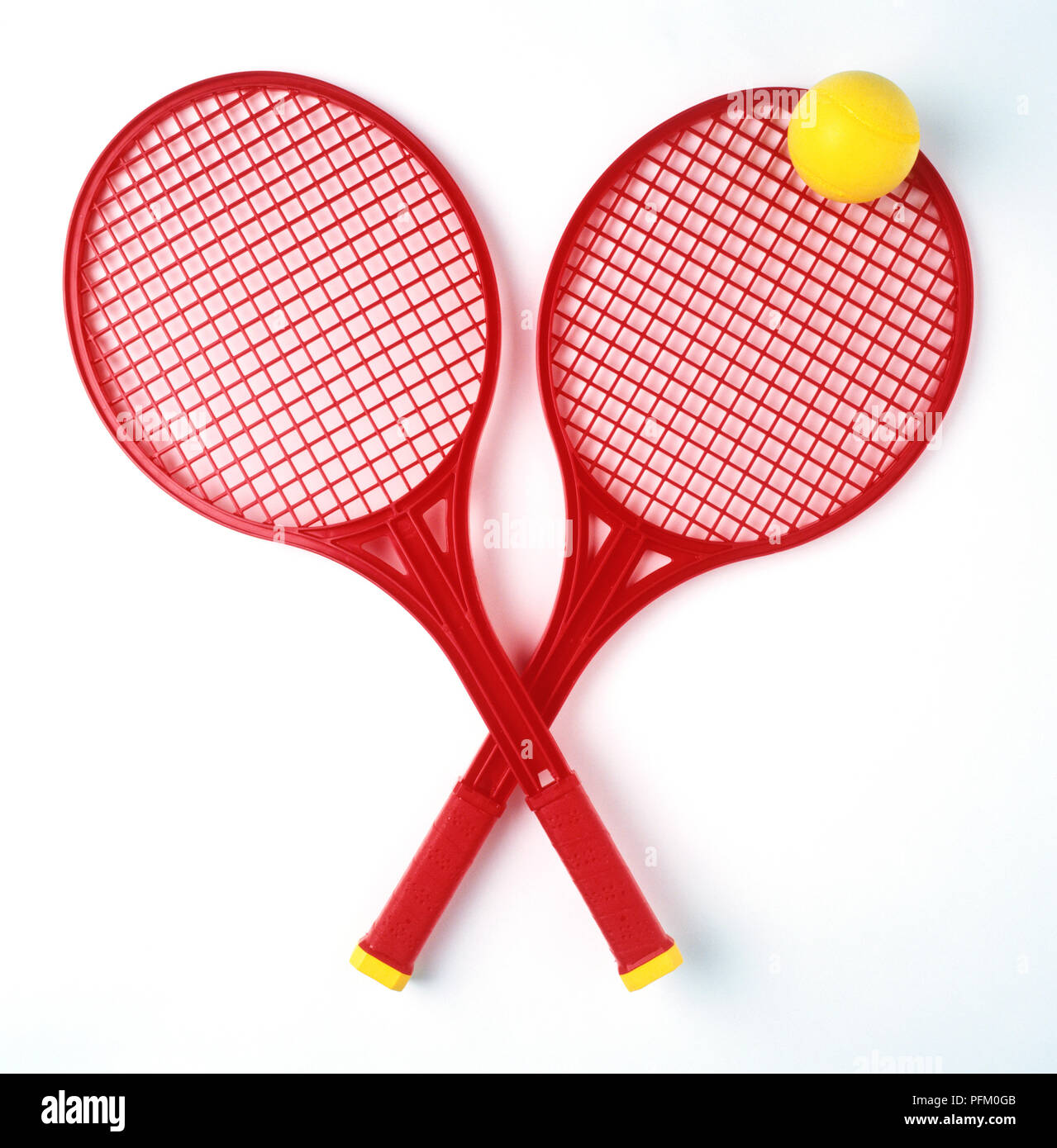 Pair of red plastic tennis rackets and foam tennis ball Stock Photo - Alamy