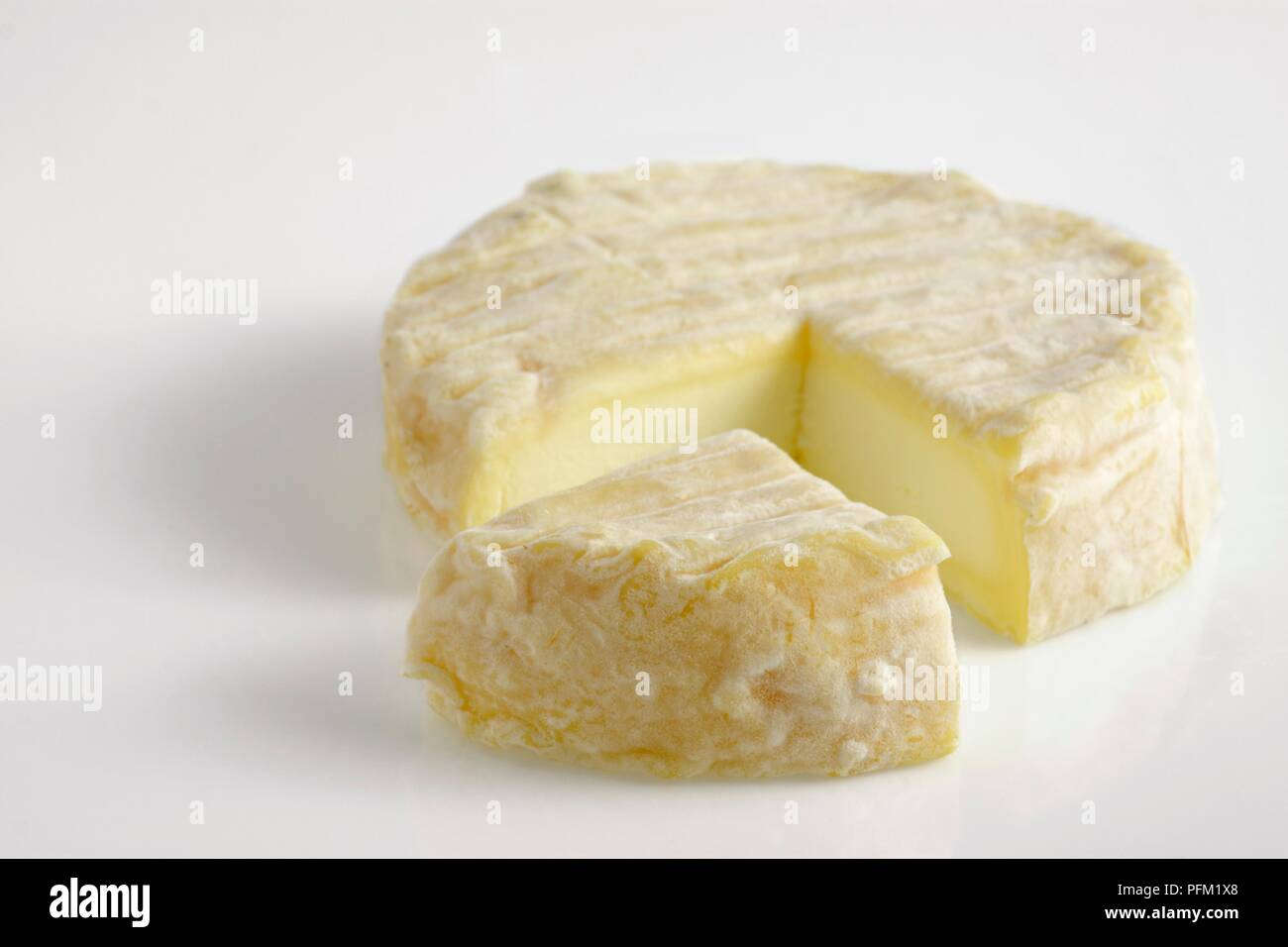 Disc and slice of French Perail ewe's milk cheese Stock Photo - Alamy