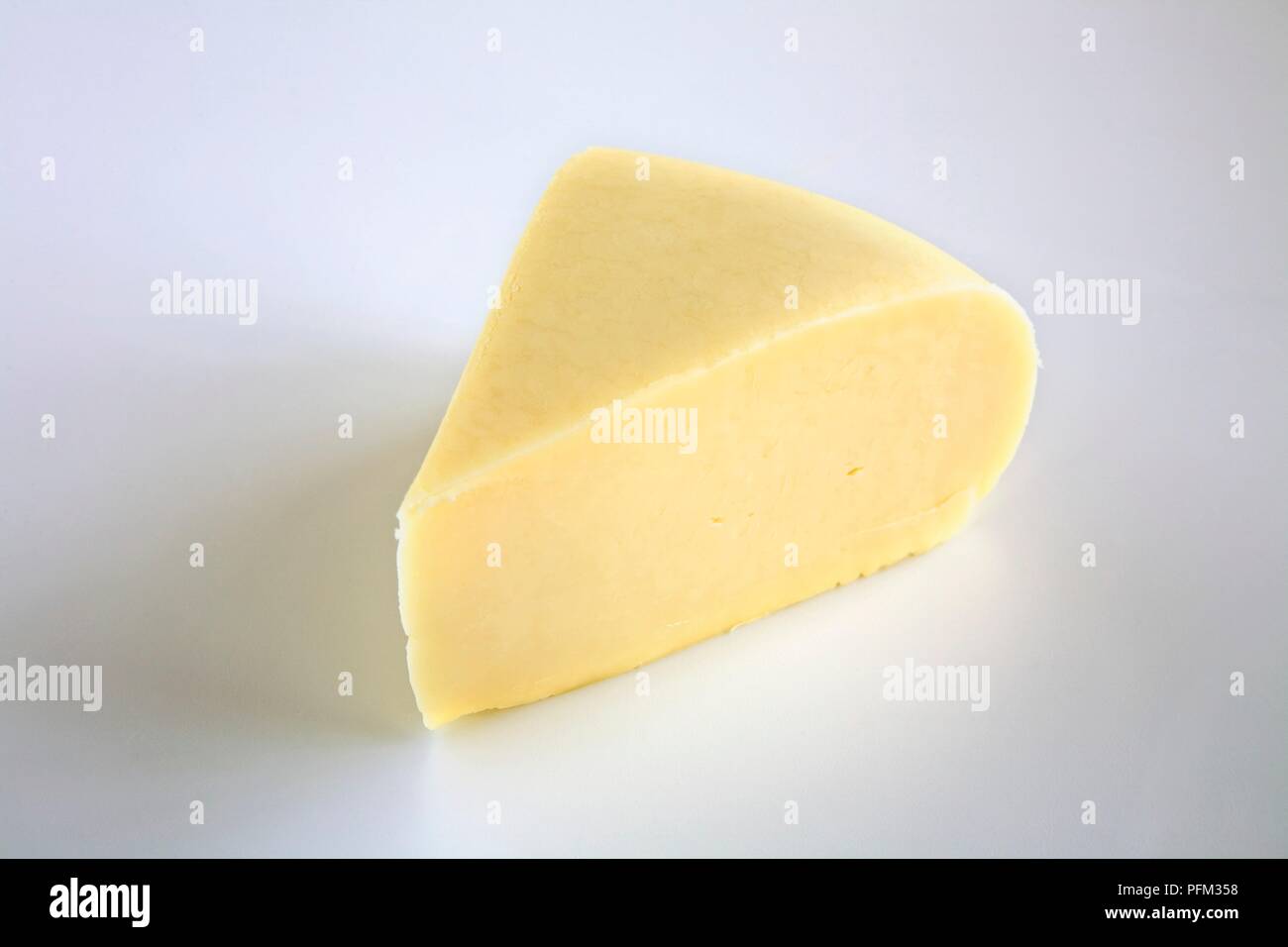 Slice of American Monterey Jack cow's milk cheese Stock Photo - Alamy