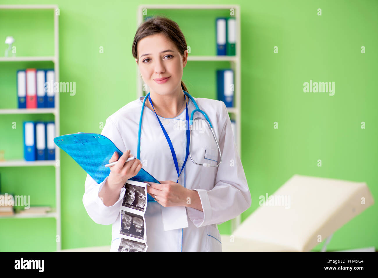 Female doctor gynecologyst writing medical record in the clinic Stock ...