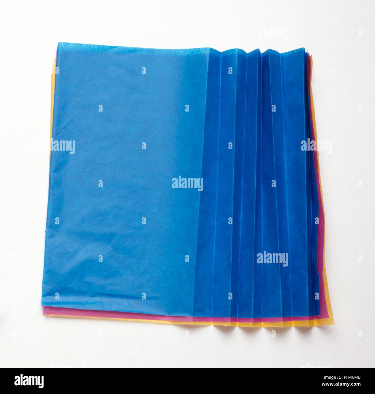 Different coloured papers folded to make a pleated pattern Stock Photo ...