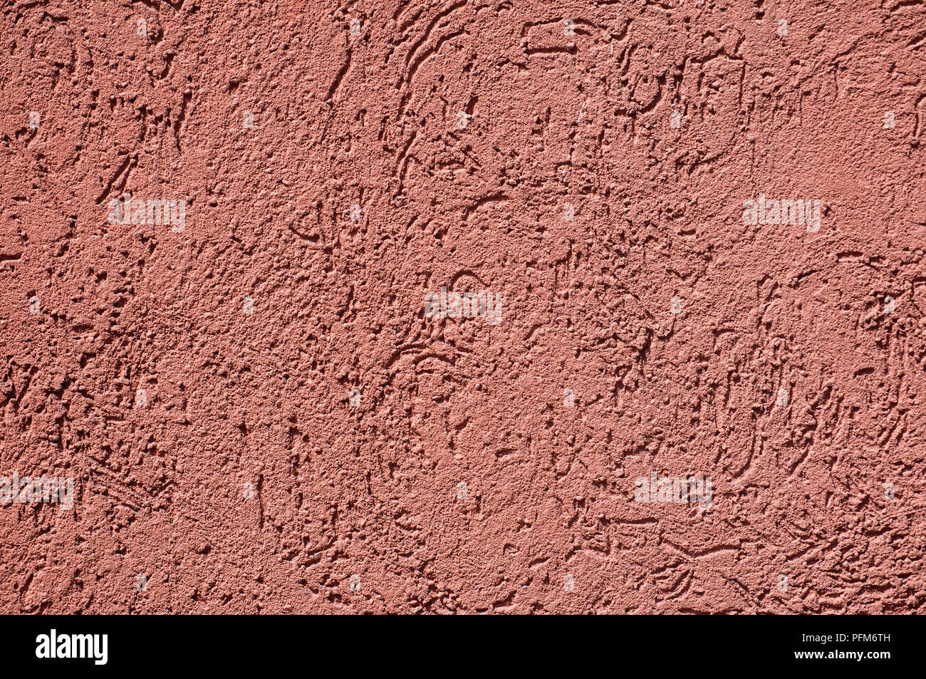 Dark pink plaster rough masonry cement house facade wall closeup as ...